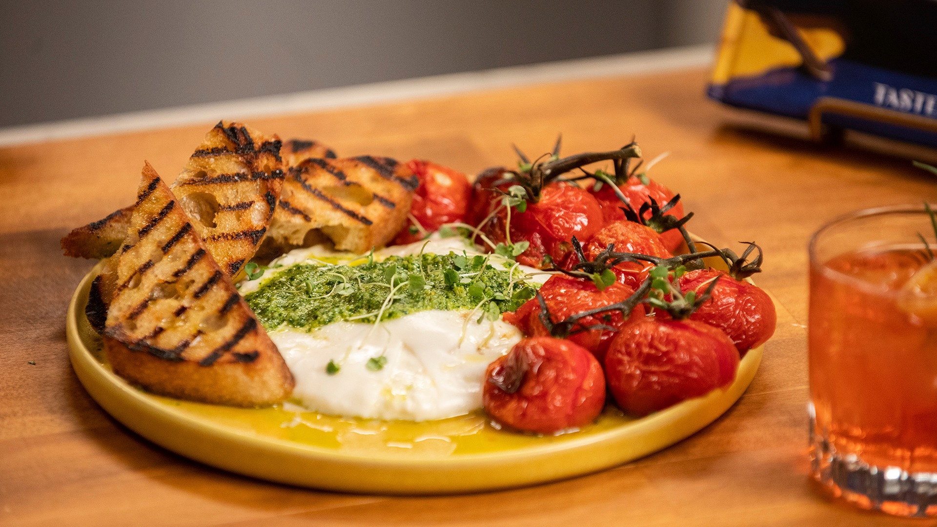 Burrata with Oven Roasted Tomatoes, Pesto and Crostini | Tastemade